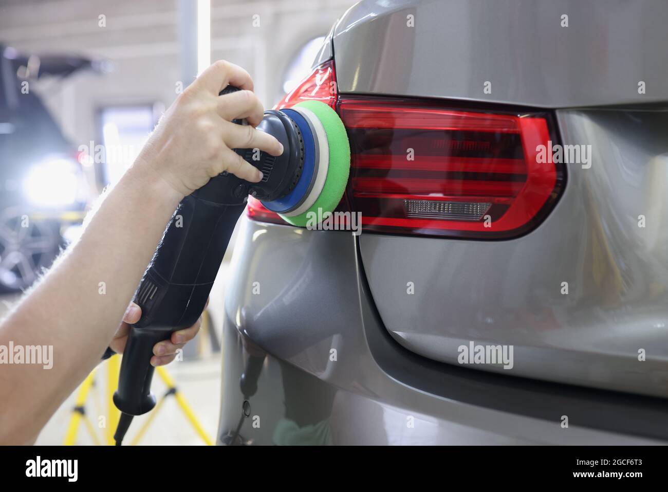 Cleaning rear lights on car from scratches with polishing machine Stock ...