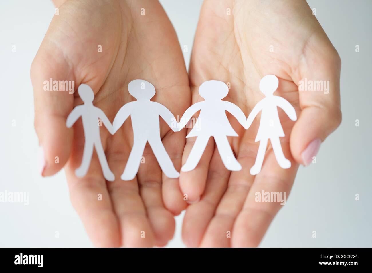 Man holding human paper figures hi-res stock photography and images - Alamy