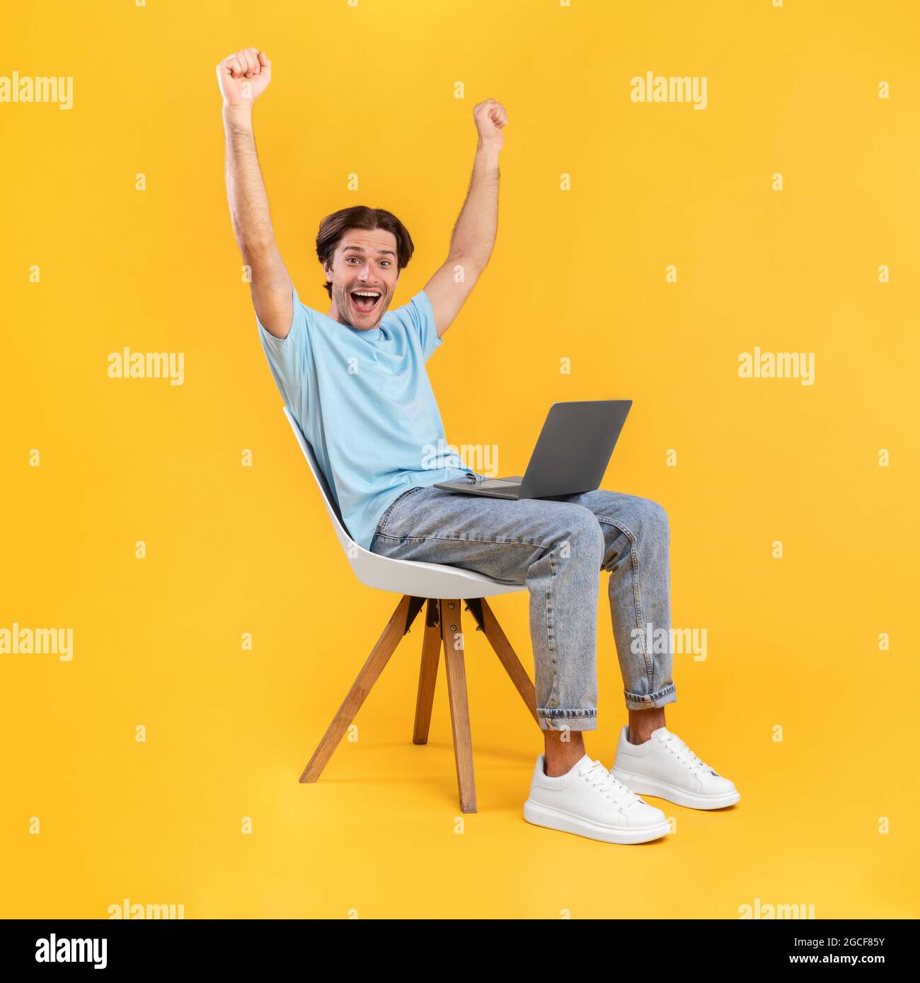 Win. Vertical portrait of excited guy celebrating success shaking ...