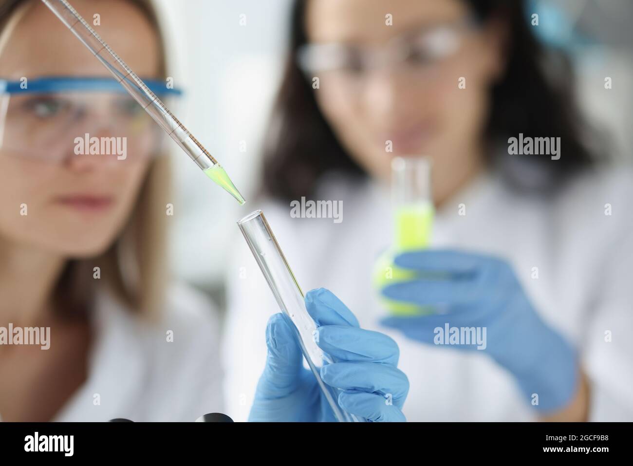 Two researchers conducting chemical research on substance Stock Photo ...