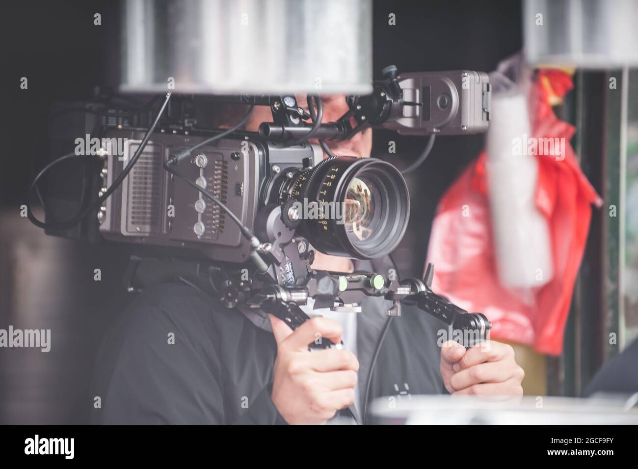 Behind the scene. Cameraman shooting the film scene with his camera on ...