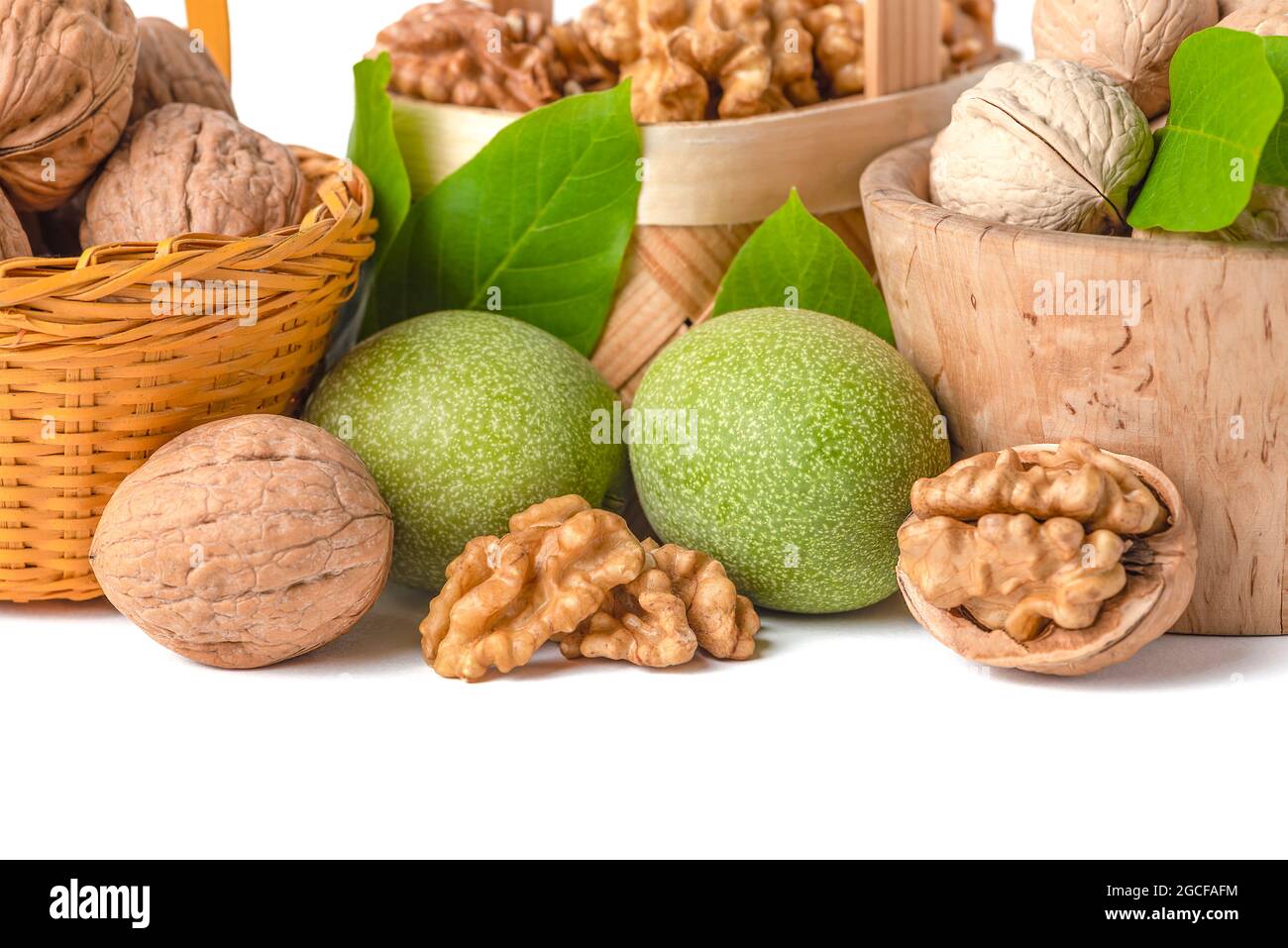 Walnut. Walnut fruits of different varieties lie in wooden saucers and ...