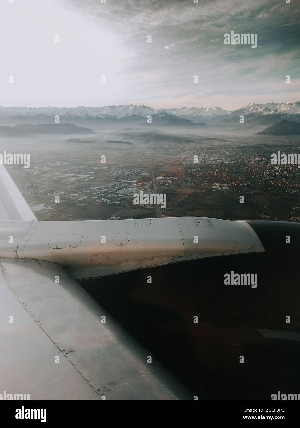 An aerial view of the cloudy sky and cityscape captured from an ...