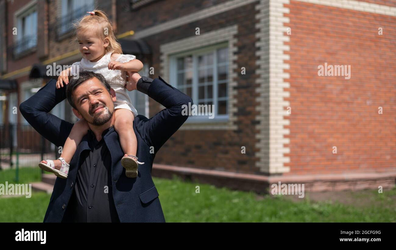 Happy girl sitting on the shoulders of adult male hi-res stock photography and images - Alamy