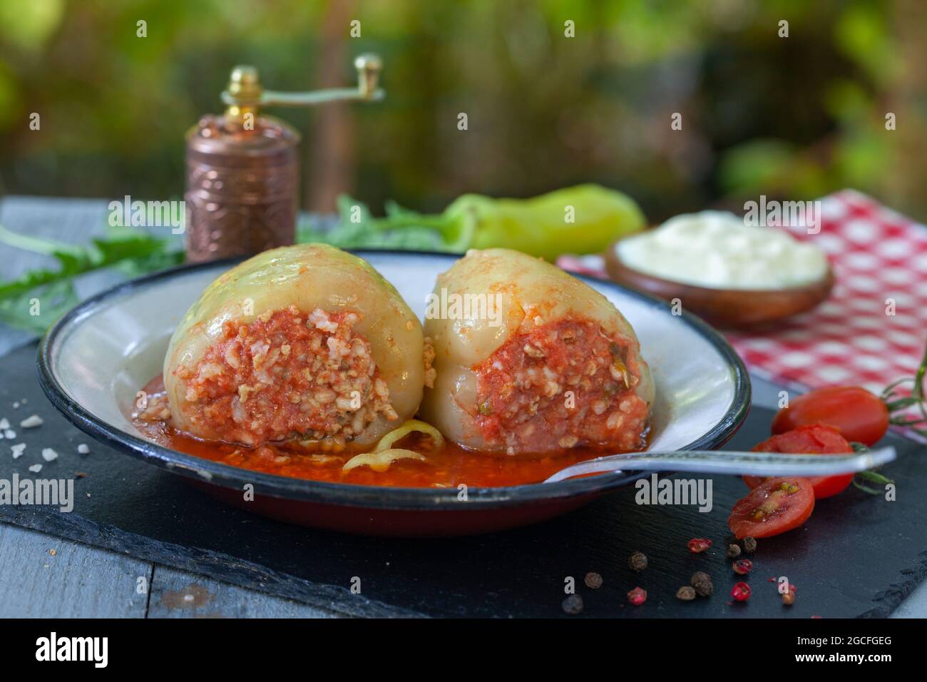 Green bell peppers stuffed with minced meat and rice in tomato sauce ...