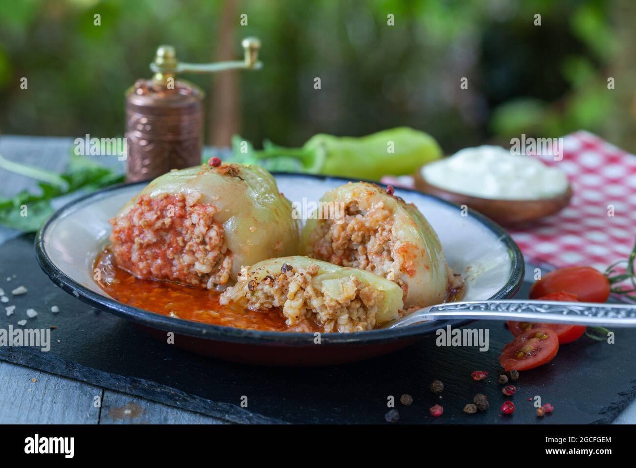 Green bell peppers stuffed with minced meat and rice in tomato sauce ...
