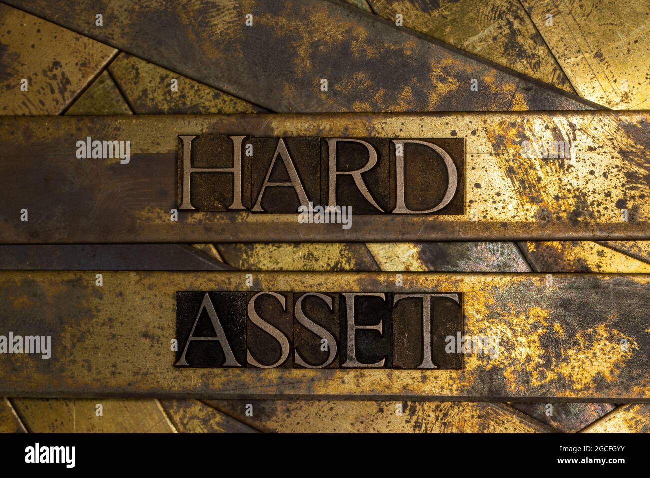 Hard Asset text on textured grunge copper and vintage gold background ...