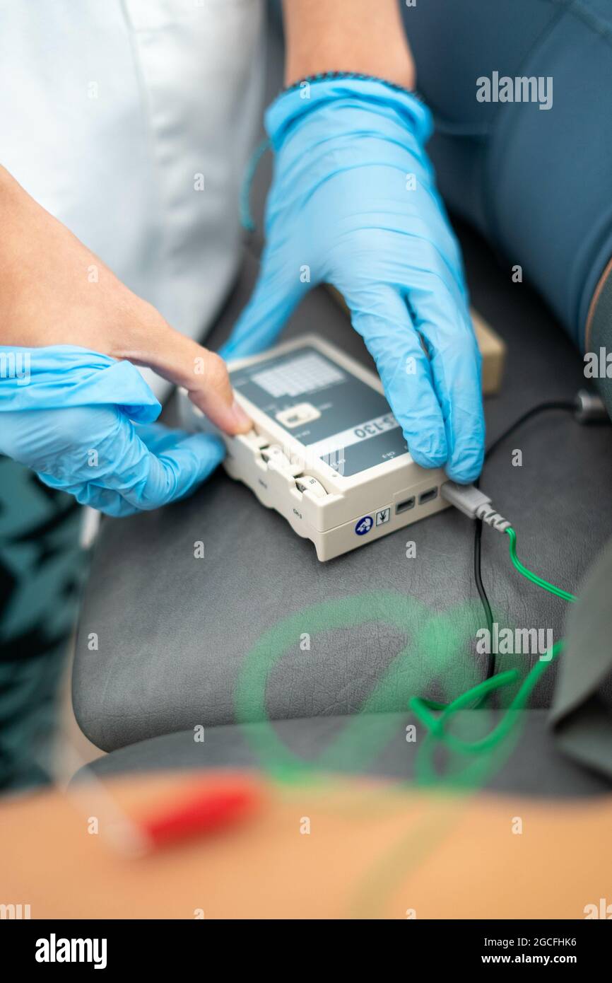 A closeup shot of a doctor regulating an acupuncture stimulator Stock ...