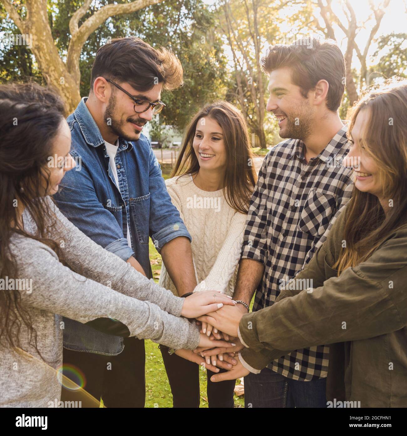 Group of friends joining their hands together Stock Photo - Alamy