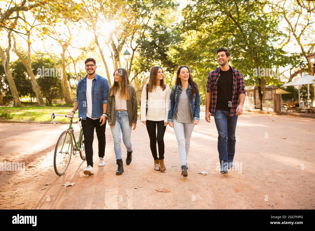 Group of students walking together in the park Stock Photo - Alamy