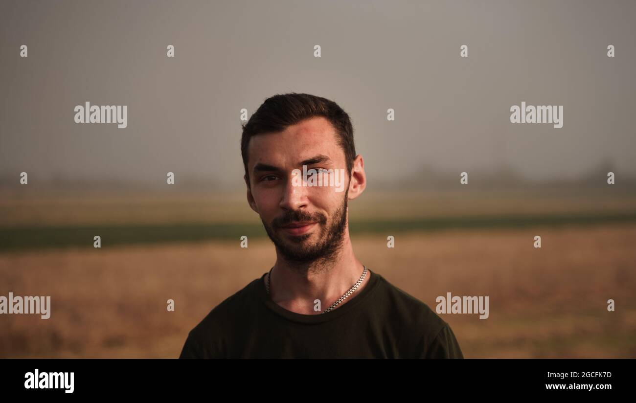 A closeup of a handsome Ukrainian man smiling at the camera on a ...