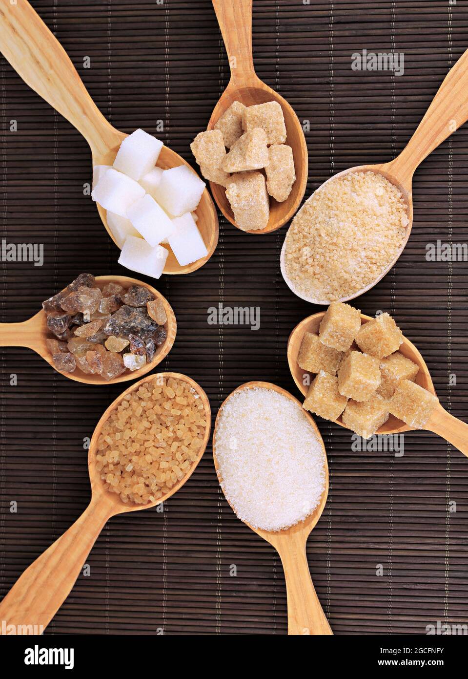 Different types of sugar in spoons on table close-up Stock Photo - Alamy