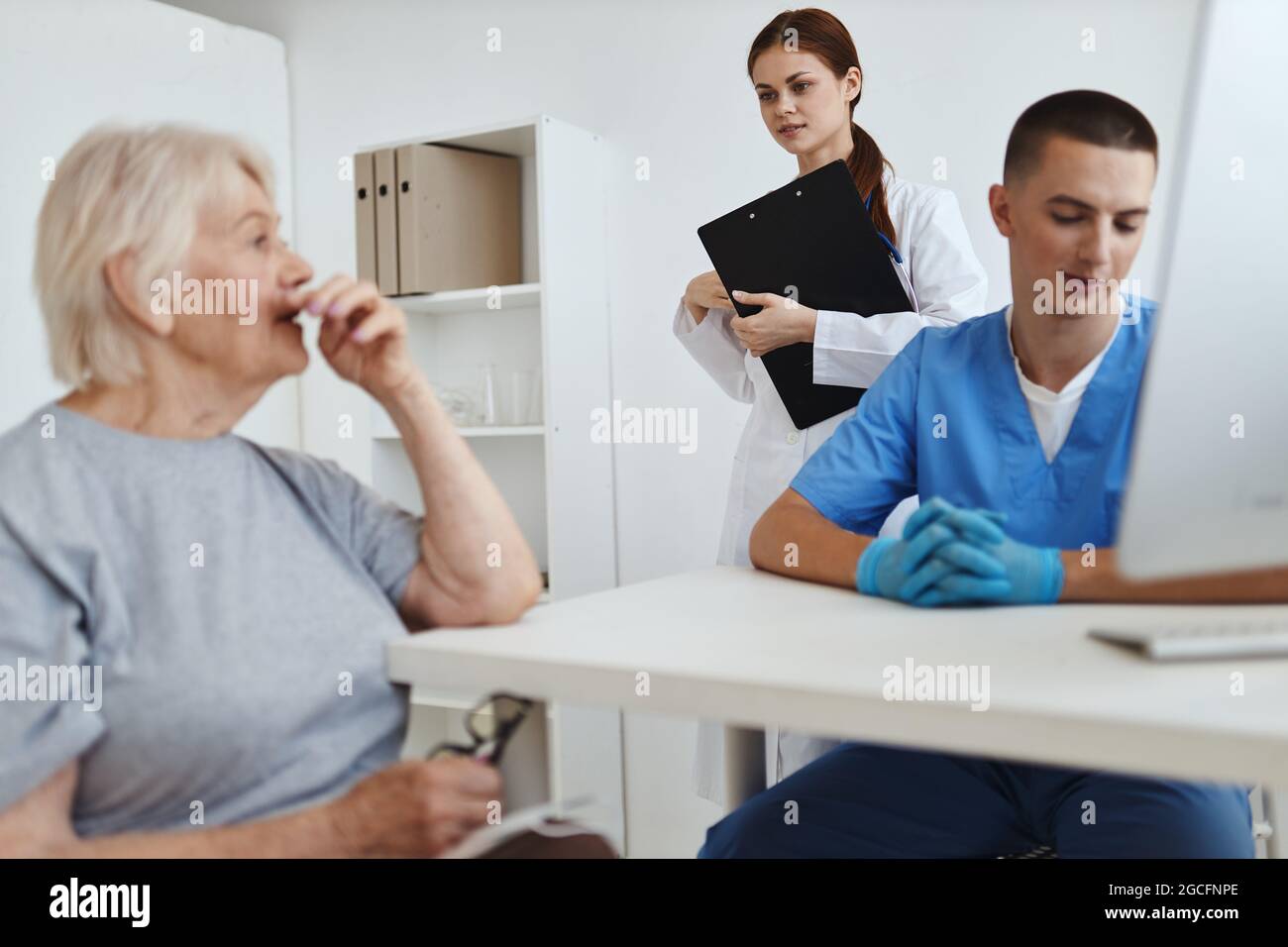 nurse and doctor communicating with woman patient health care Stock ...