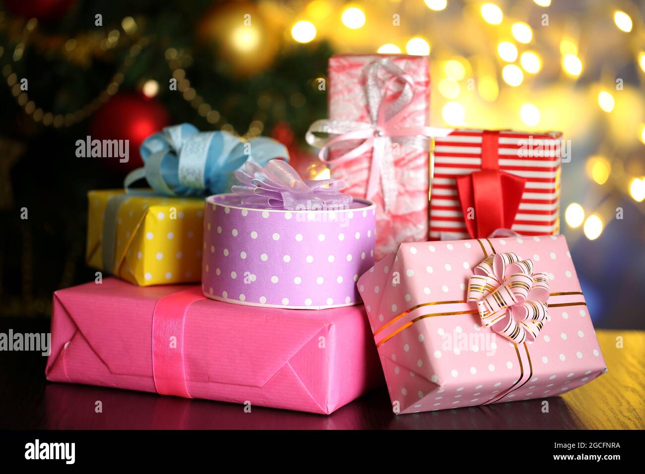 Many gifts on table on bright background Stock Photo - Alamy