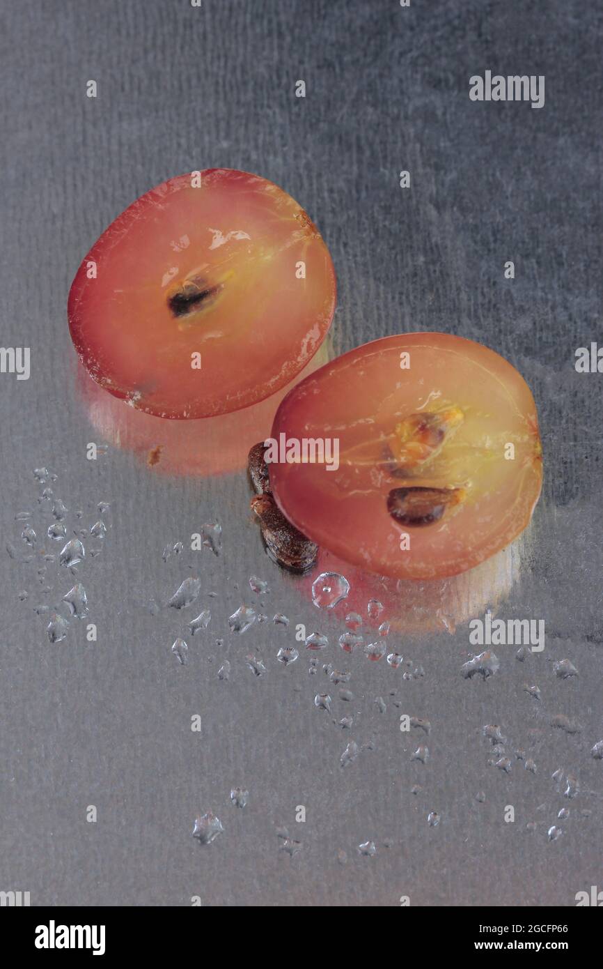 Ripe sliced grape and seeds, close up Stock Photo - Alamy