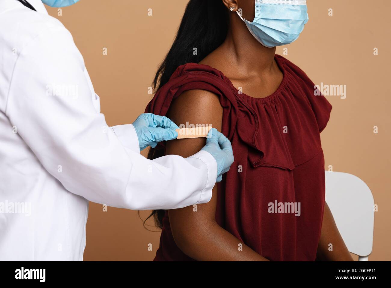 Nurse hands in protective medical gloves putting medical band after ...