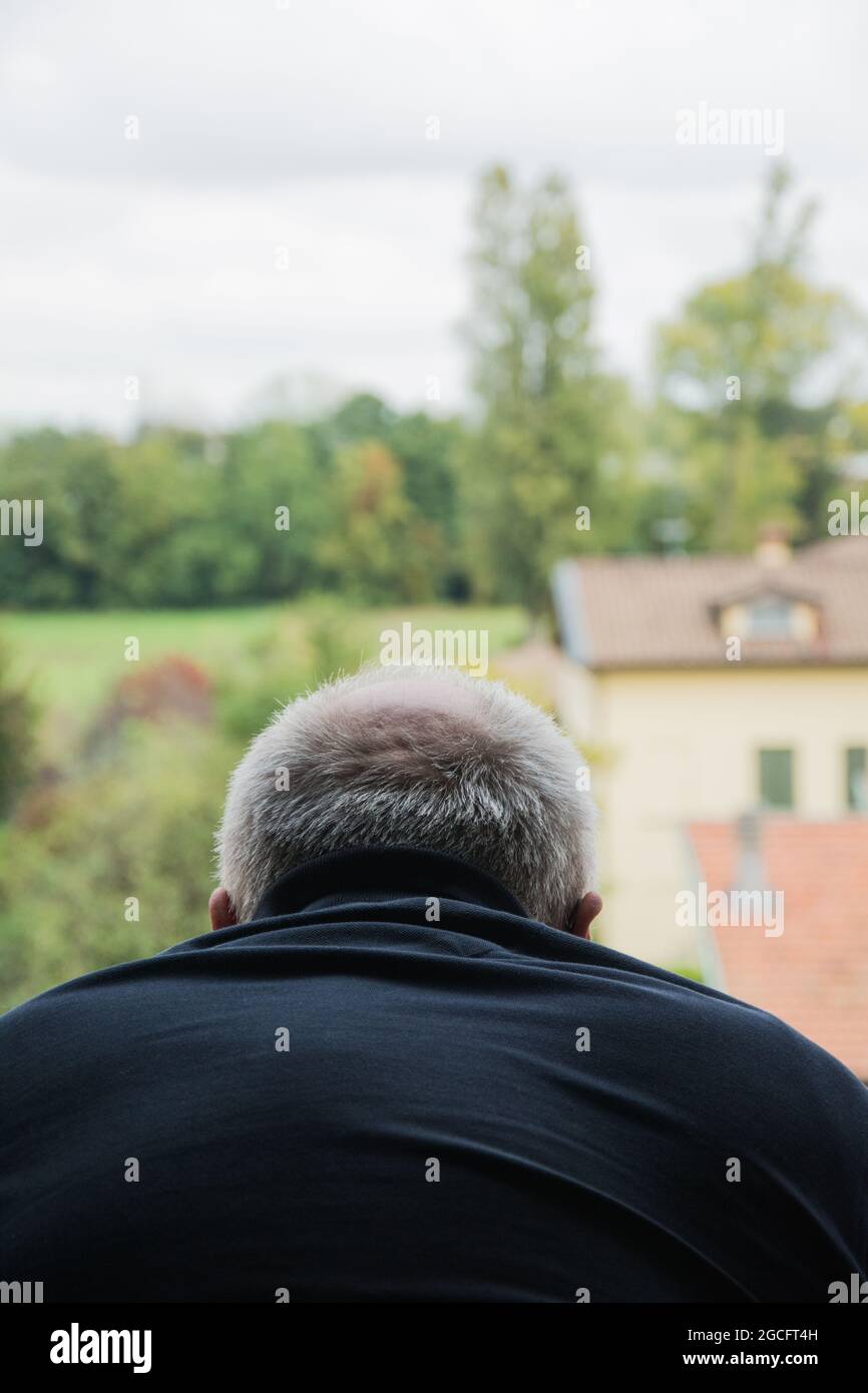 A back view of a senior male watching the countryside scenery Stock ...