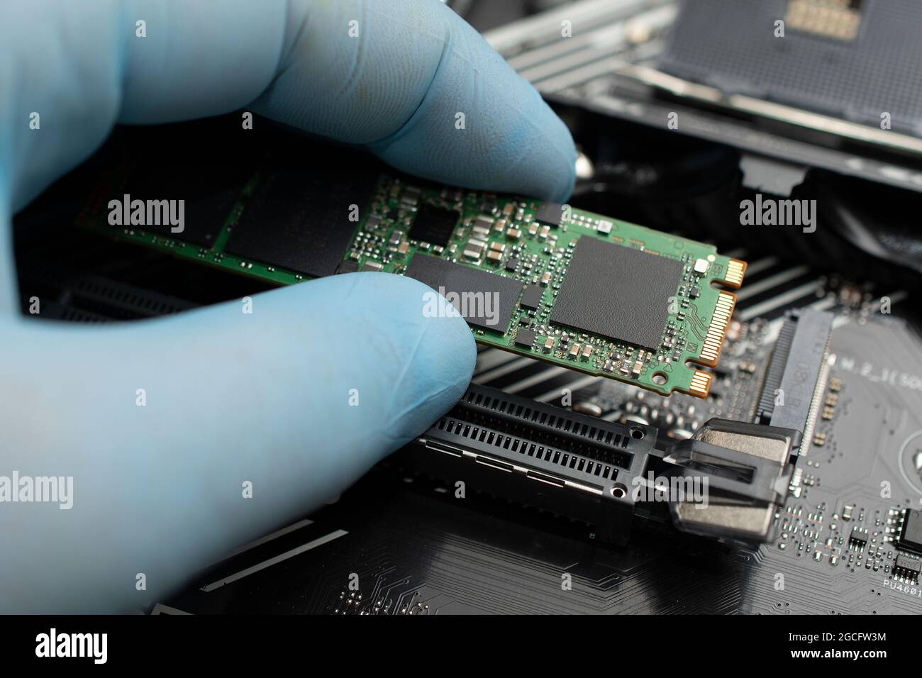 Technician connects an ssd hard drive to a motherboard Stock Photo - Alamy