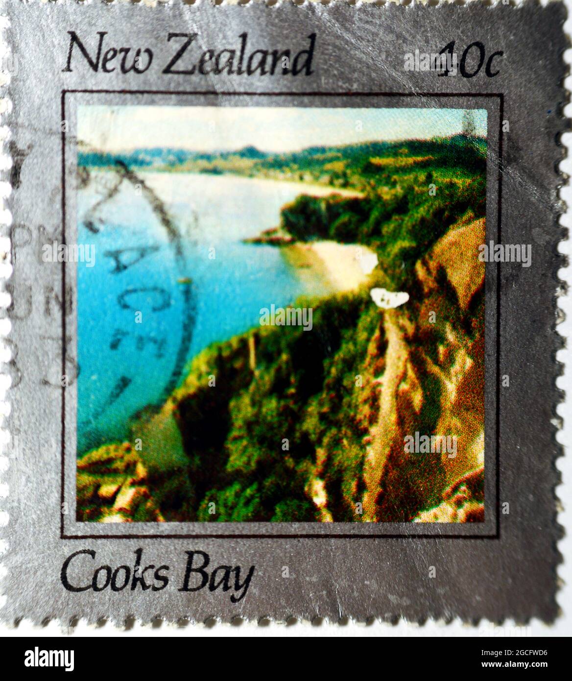 An old used postage stamp printed in New Zealand shows Cooks Bay a ...
