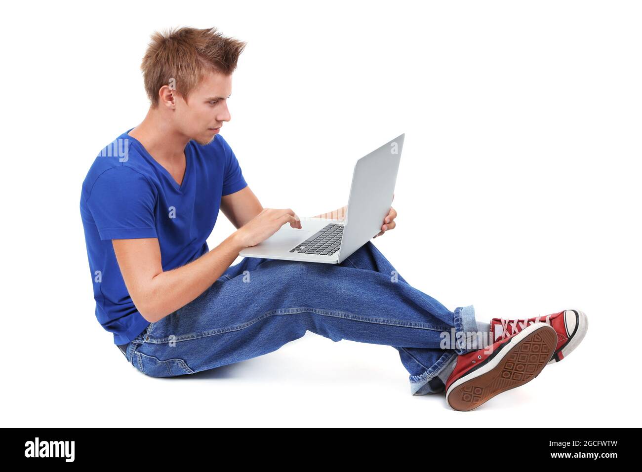 A handsome young man with laptop isolated on white Stock Photo - Alamy