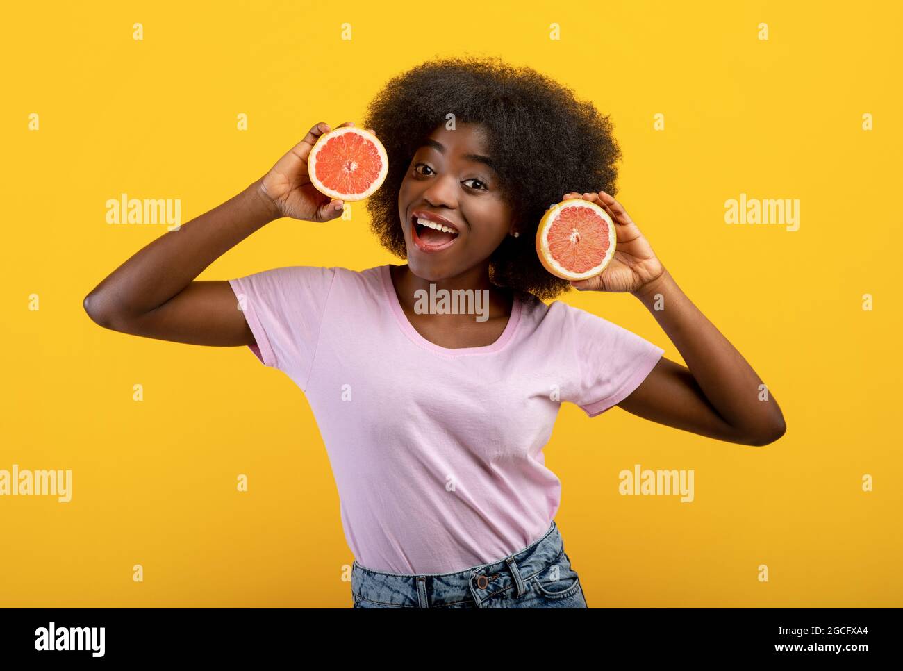 Vitamins for beauty and skin care concept. Playful black lady posing ...