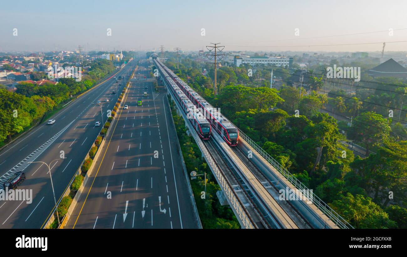 Aerial view of LRT train moving from station on the elevated tracks ...