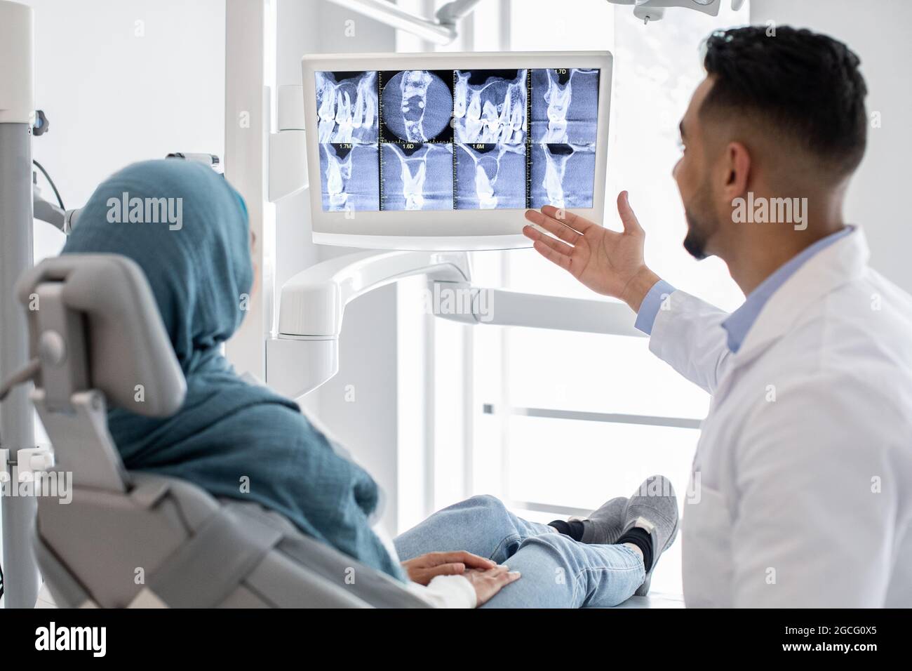 Arab Male Dentist Showing Treatment Result At Teeth Xray Picture To ...