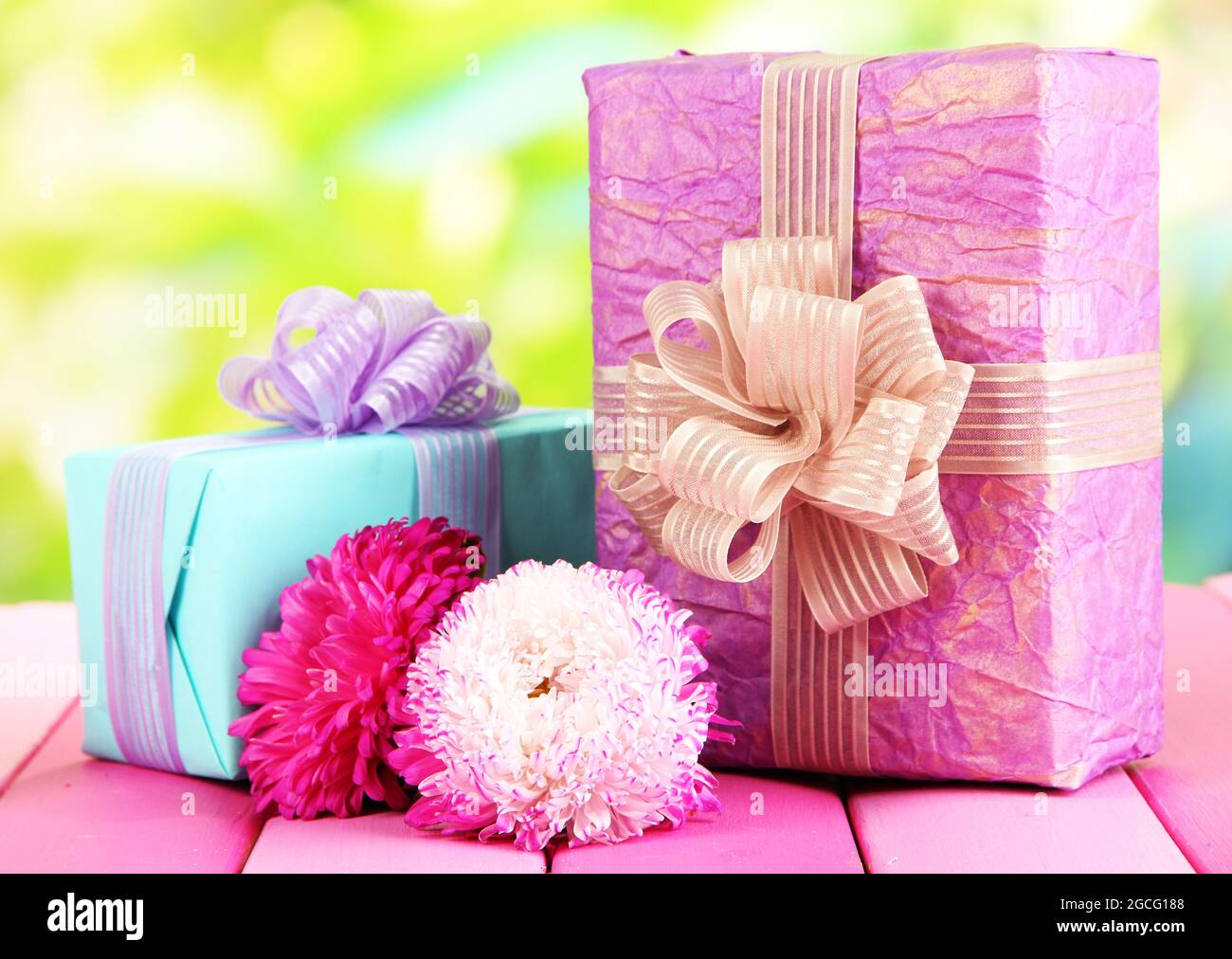 Gifts and flowers, on nature background Stock Photo - Alamy