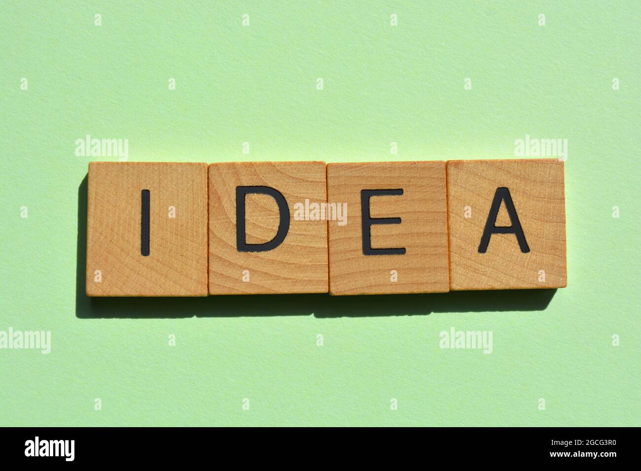 Idea, word in wooden alphabet letters isolated on green background as ...