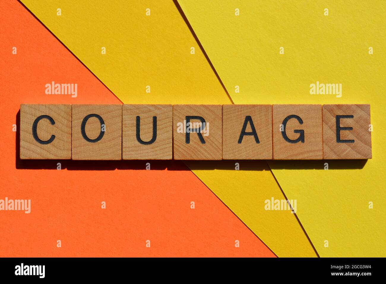 courage, word in wooden alphabet letters isolated on orange and yellow ...