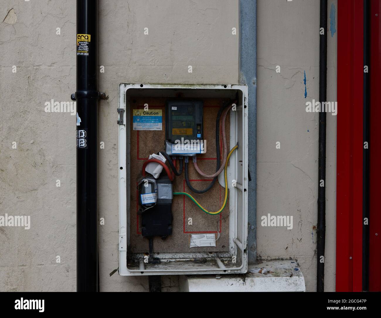 A box with domestic electric connections is seen without cover in the ...