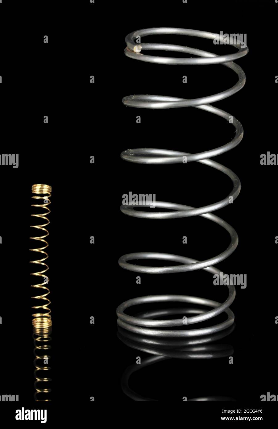 Coil spring on black background Stock Photo - Alamy