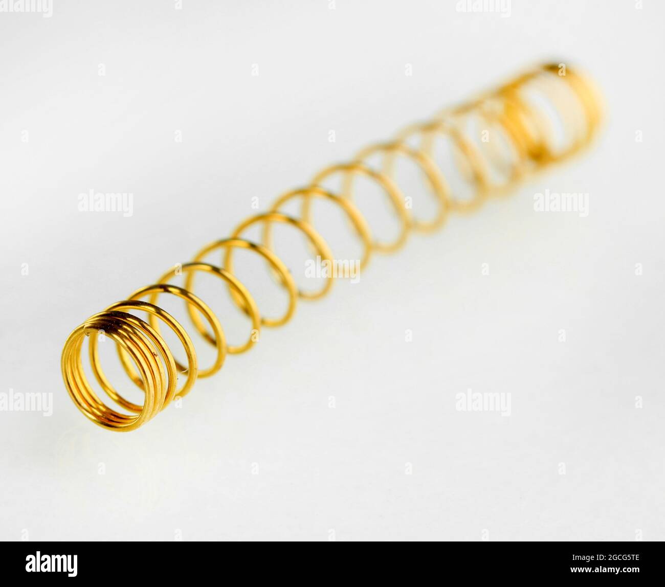 Coil spring isolated on white Stock Photo - Alamy