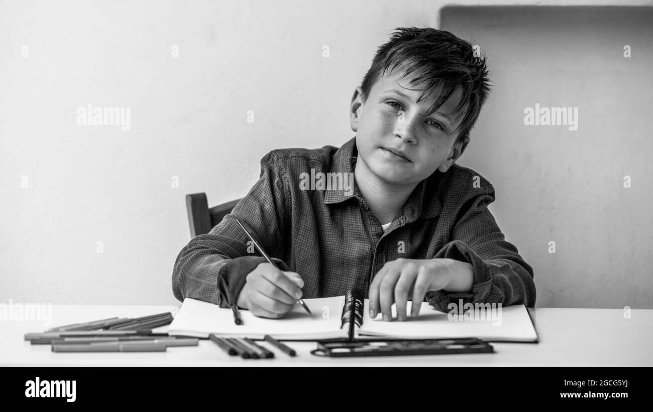 Student of elementary school doing homework. Black and white photo ...