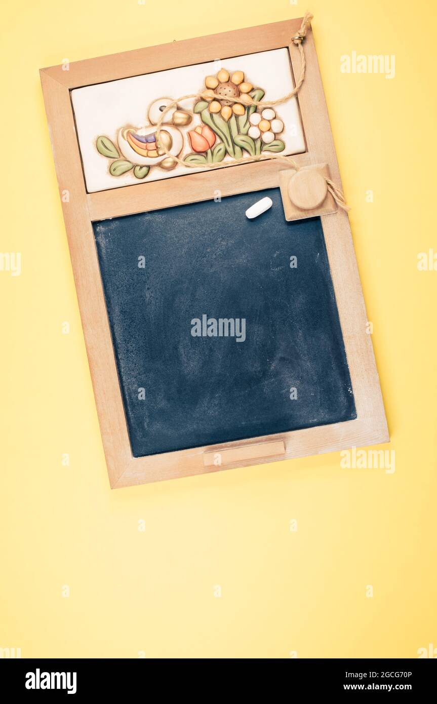 A top view of a small wall chalkboard for schedules on orange ...