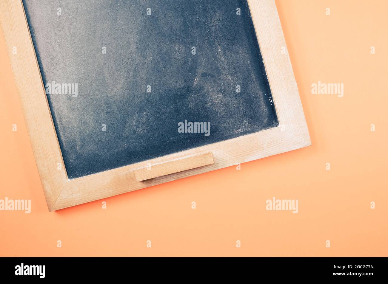 A top view of a small wall chalkboard for schedules on orange ...