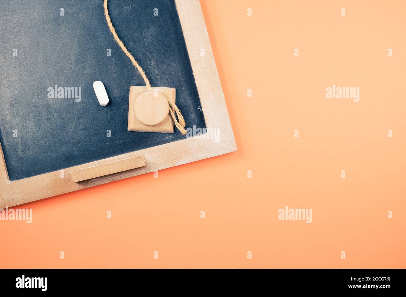 A top view of a small wall chalkboard for schedules on orange ...
