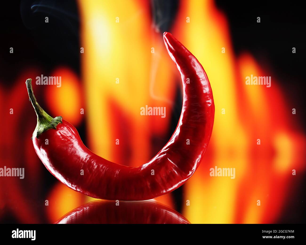 Red hot chili pepper on fire background Stock Photo - Alamy