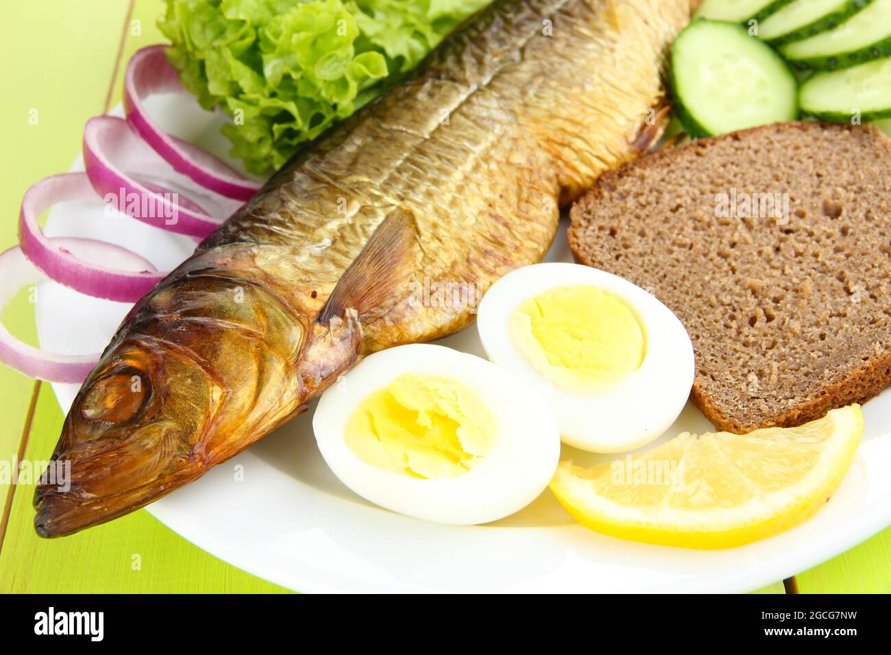 Smoked fish on plate close up Stock Photo - Alamy