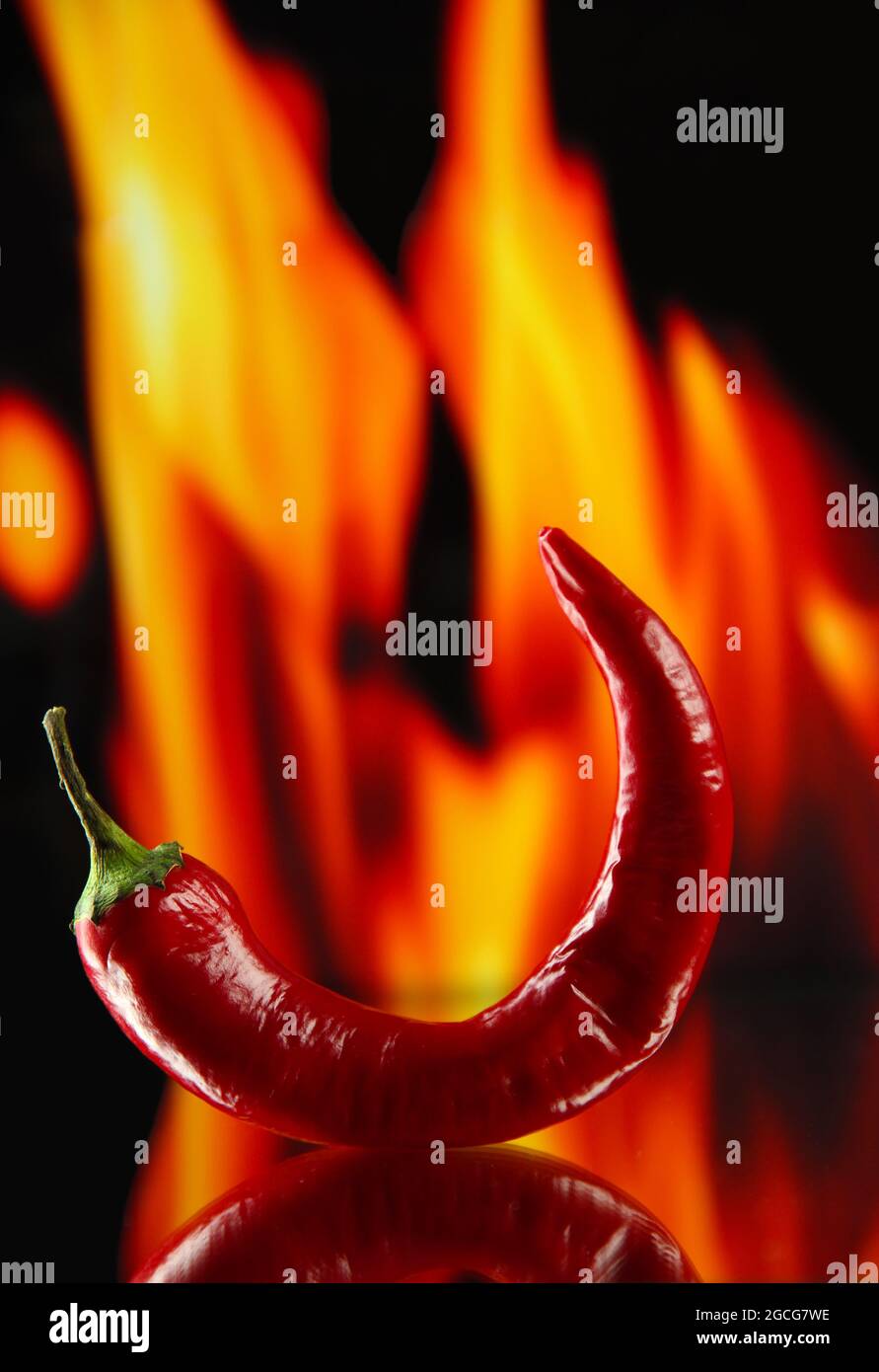 Red hot chili peppers on fire background Stock Photo - Alamy