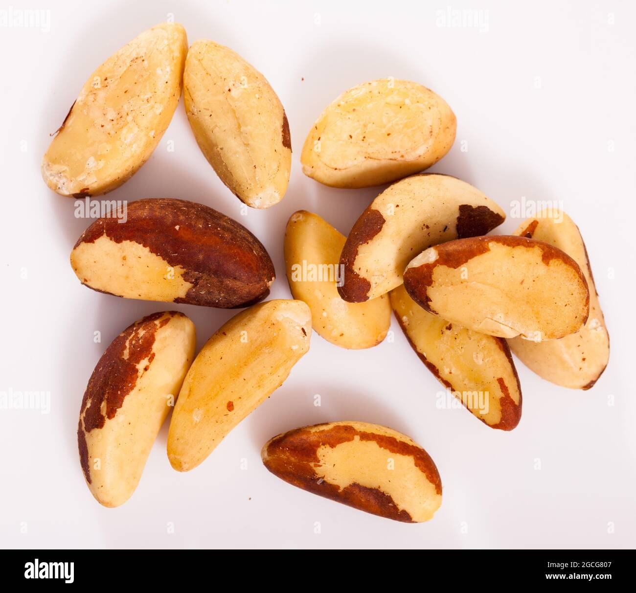Brazil nut seeds on white surface Stock Photo - Alamy