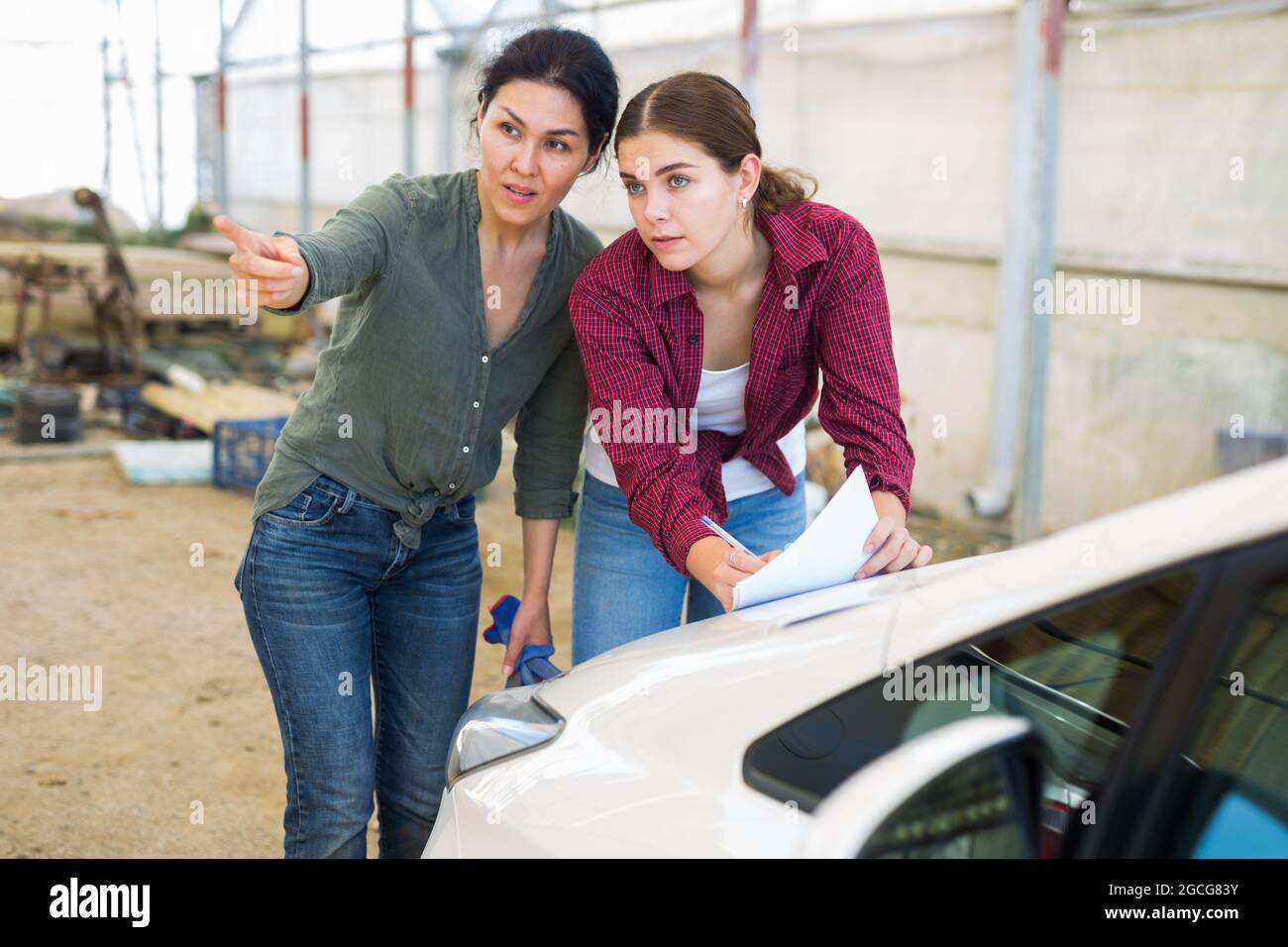 Woman and girl talking about documentation Stock Photo - Alamy