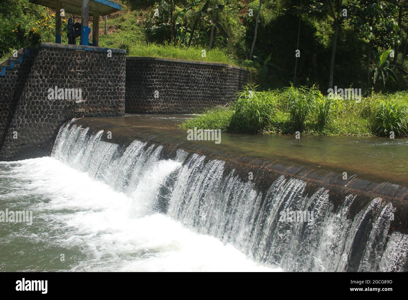river water flows in the ancient water dam for rice fields irrigation ...