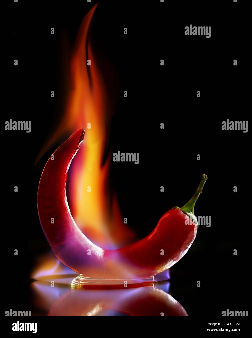 Red hot chili pepper on fire on black background Stock Photo - Alamy