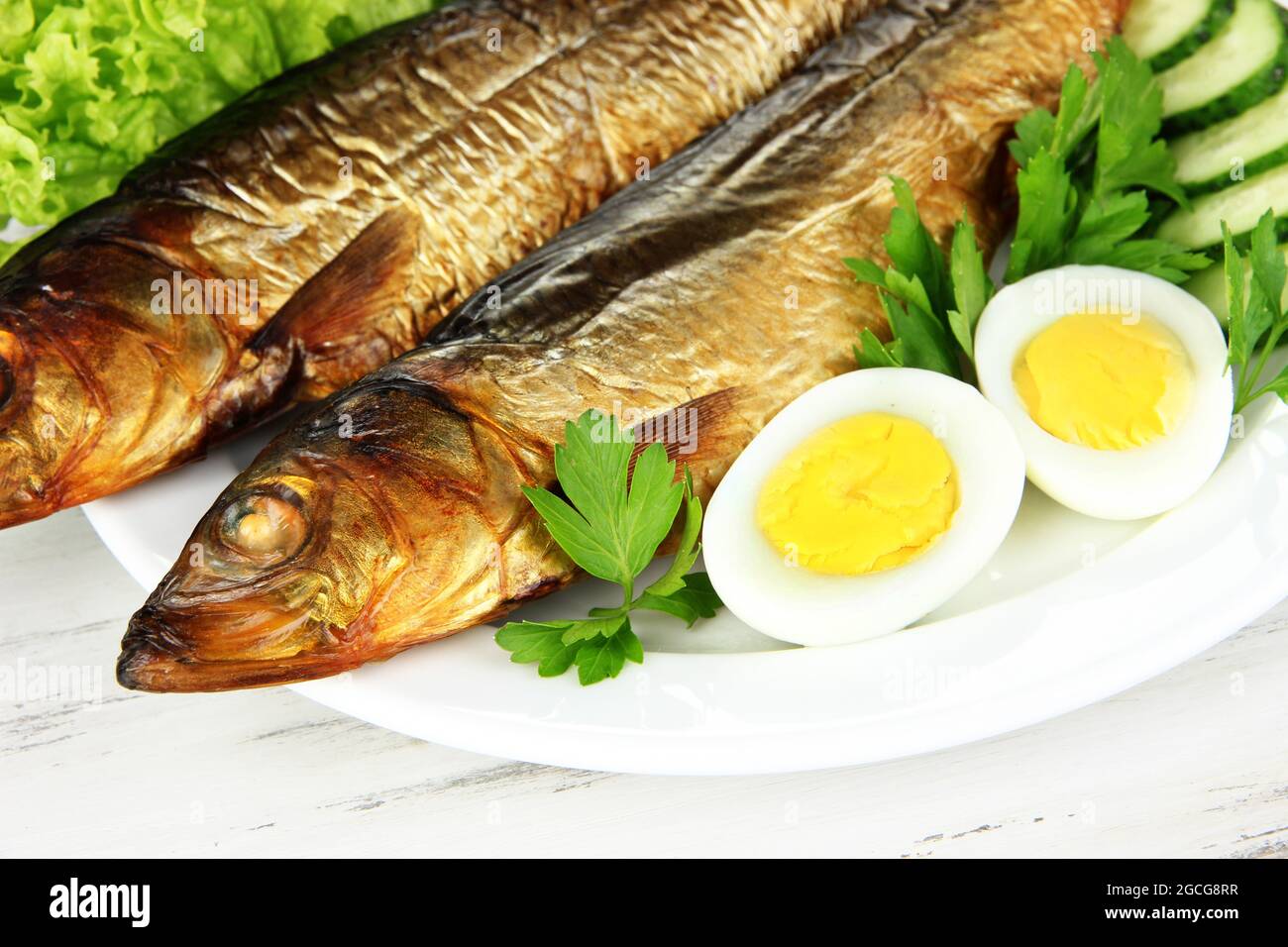 Smoked fish on plate close up Stock Photo - Alamy