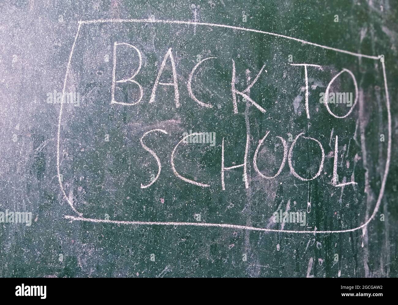 A back to school written with chalk on a green weathered chalkboard ...