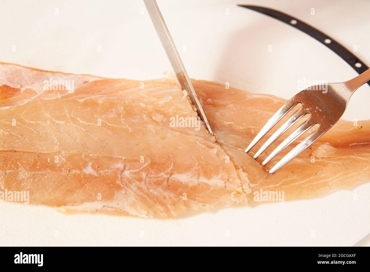 Fish marinade preparation steps: Cutting a sea bass fillet Stock Photo ...