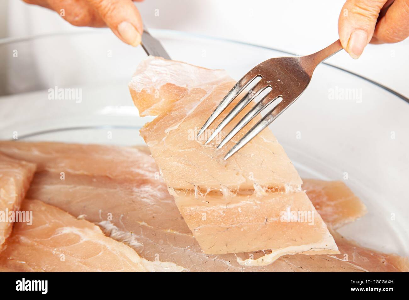 Fish marinade preparation steps: Cutting a sea bass fillet Stock Photo ...