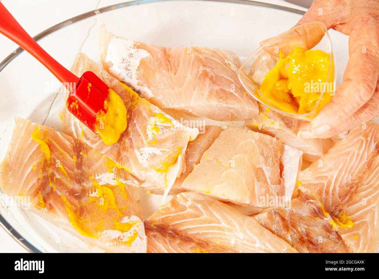 Fish marinade preparation steps: Spreading the fish with mustard Stock ...