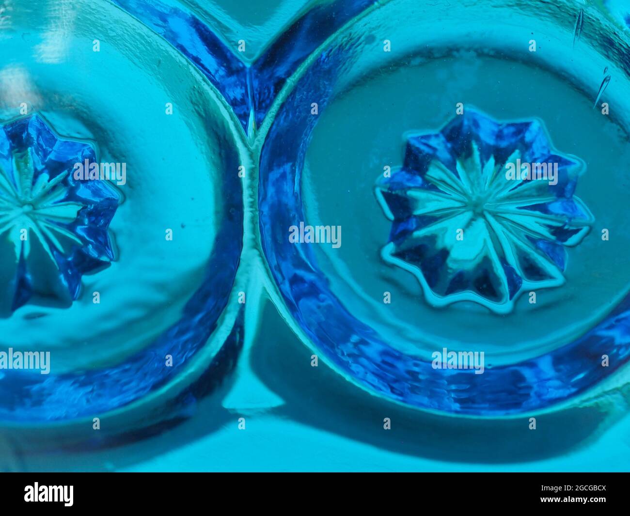 A close up photograph of Blue Carnival Glass pattern Stock Photo - Alamy